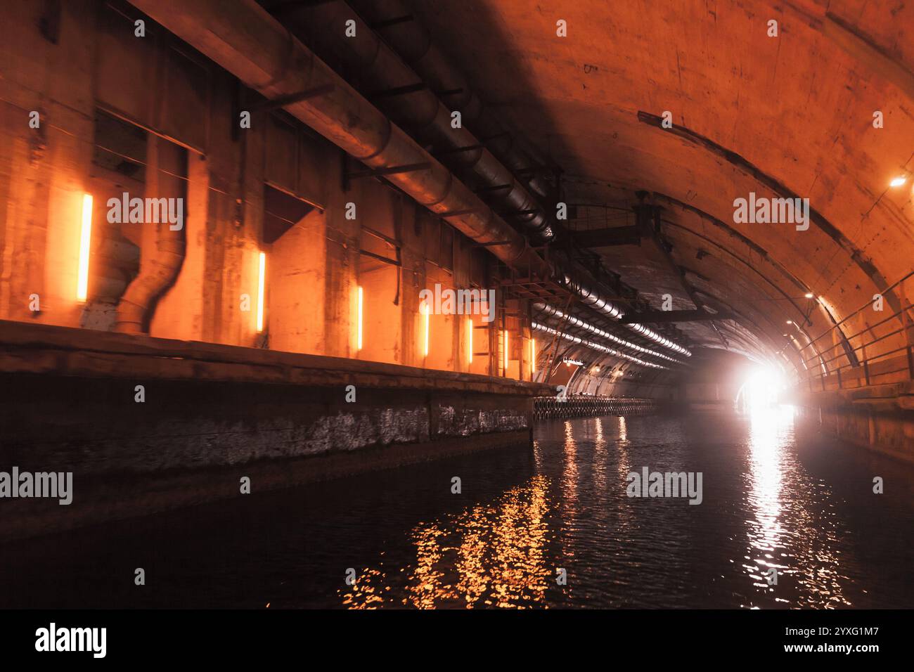 Illuminated concrete tunnel with glowing end. Abandoned underground ...