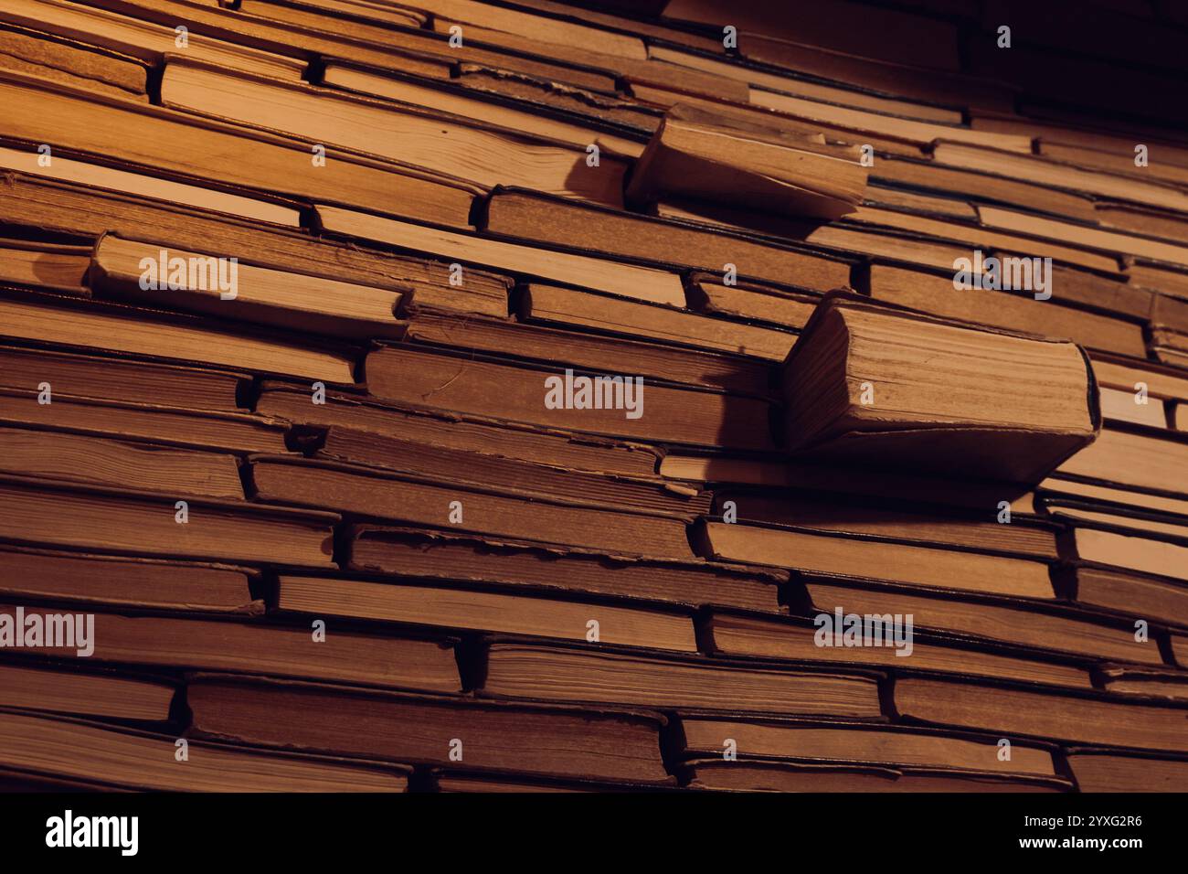 Antique bookshelf background in warm light. Pile of old books. Archive ...