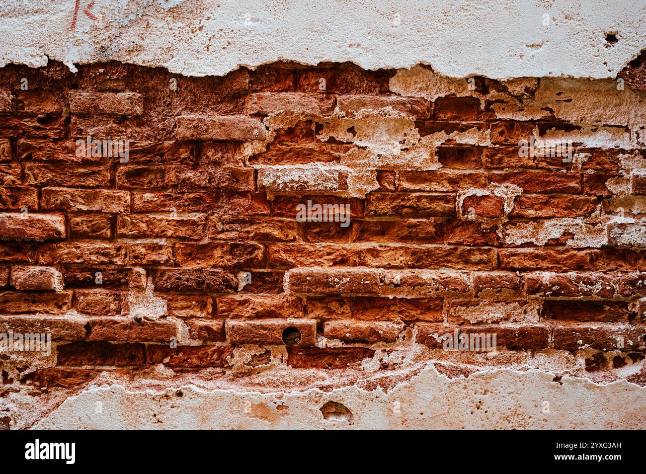 Brick wall with pieces of plaster. Wall of an old building in need of ...