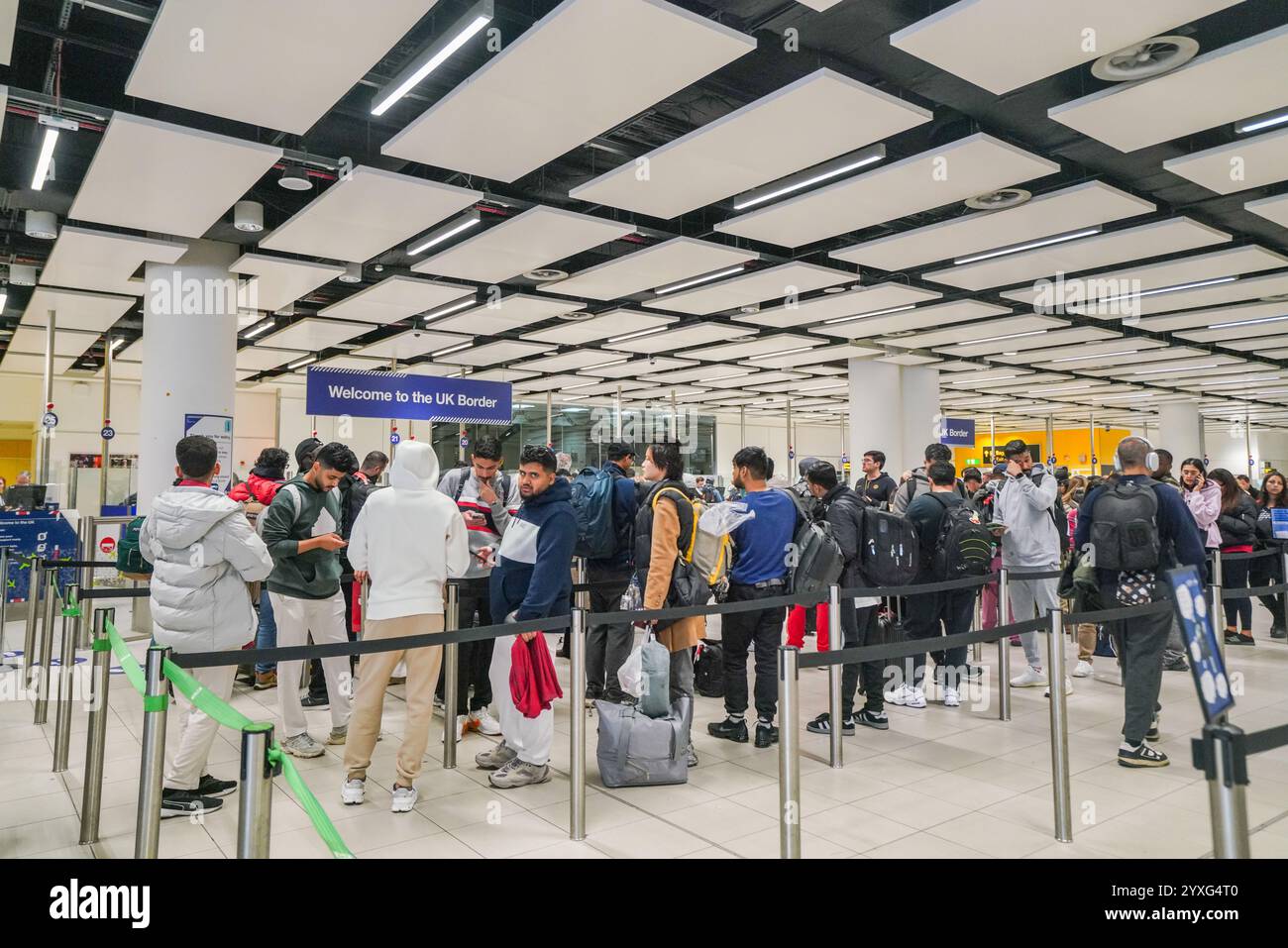 Gatwick, UK. 16 December 2024 Passengers queuing at the UK Border passport control at Gatwick ...