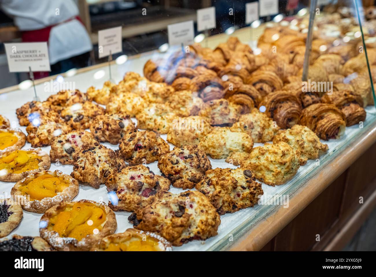 Pastry, croissants, cookies on display in a bakery . Modern bakery with ...