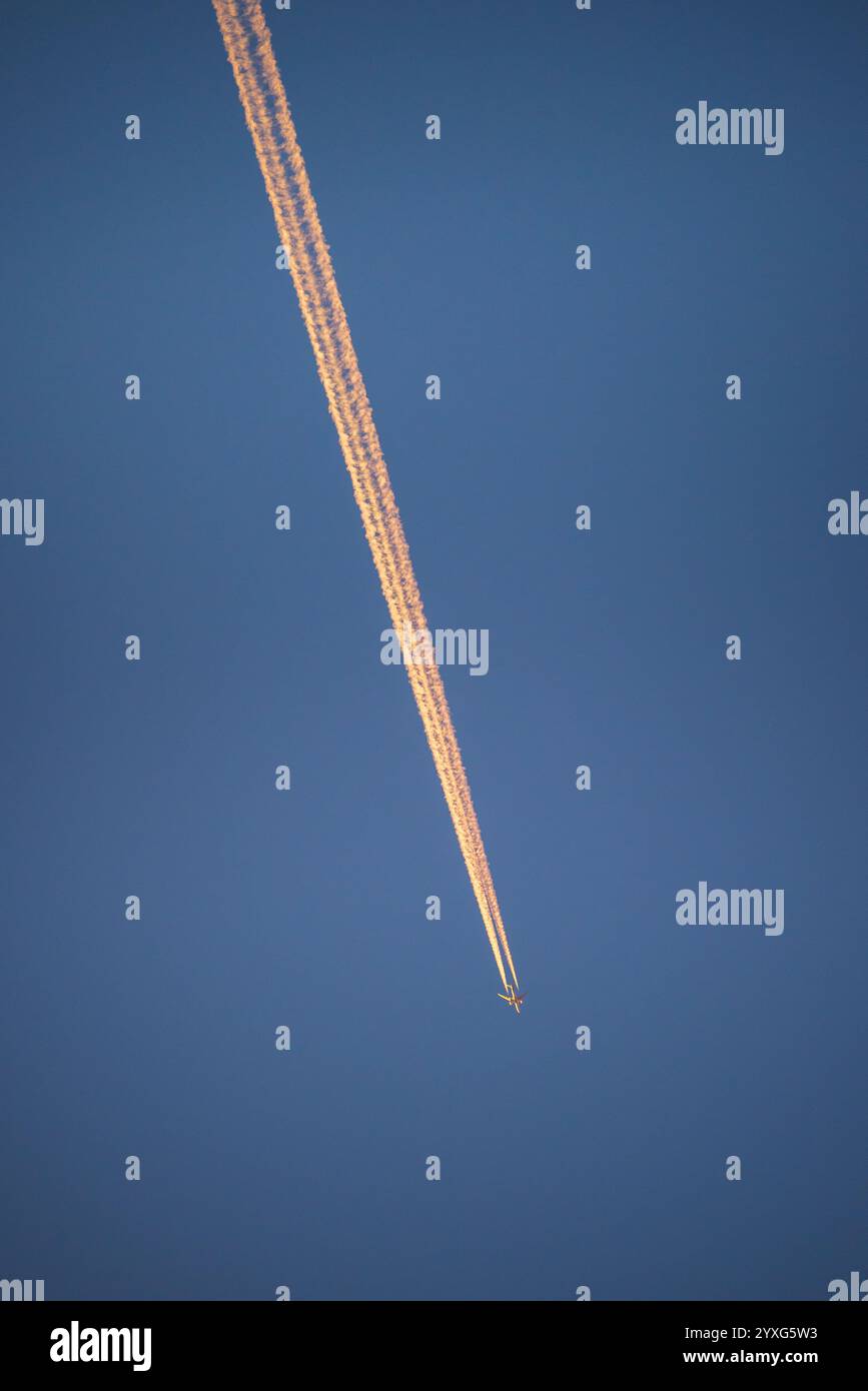 Contrails in the sky from a passenger jet plane Stock Photo - Alamy