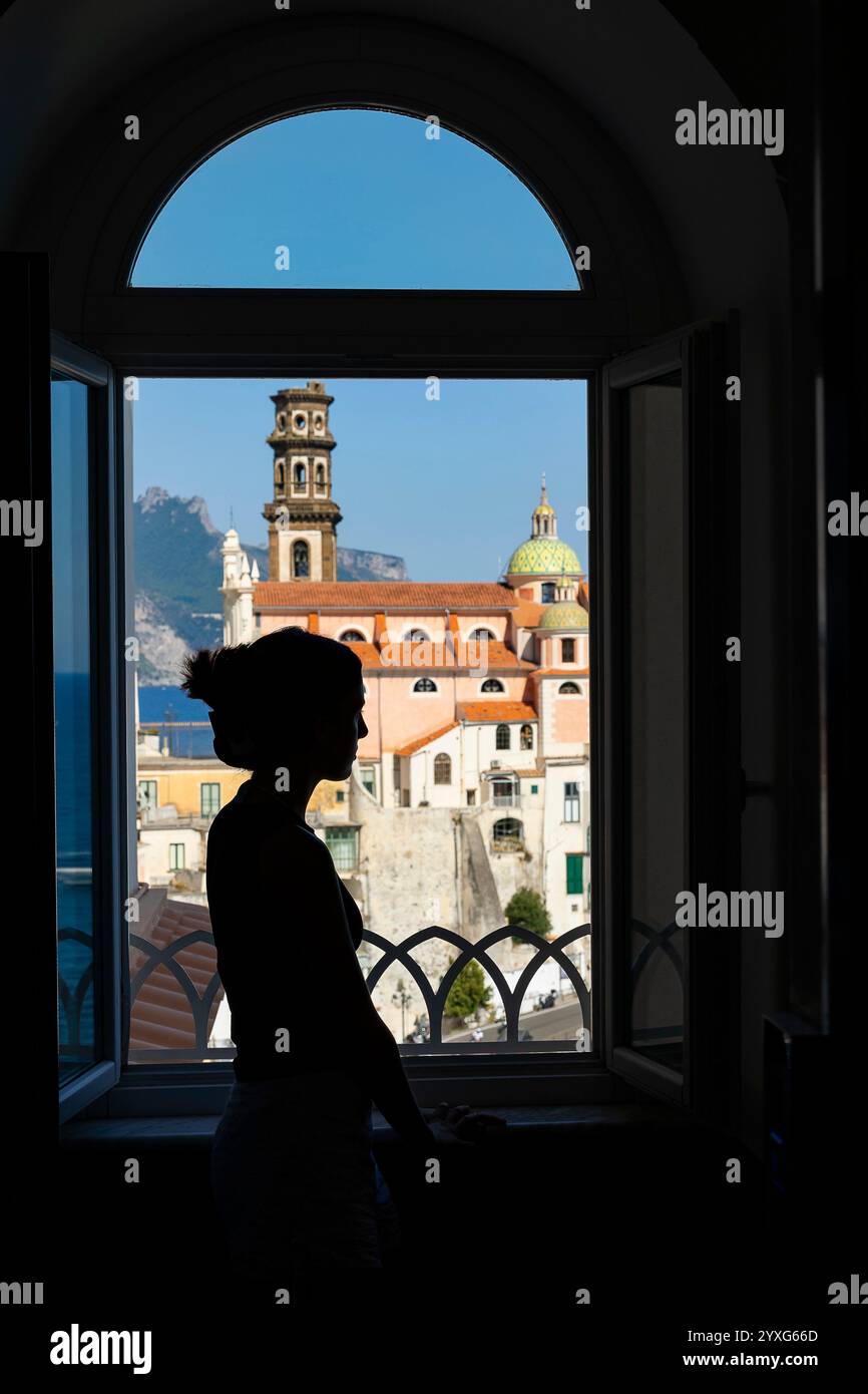Woman in silhouette looking at the window, Atrani, Amalfi coast, Italy ...
