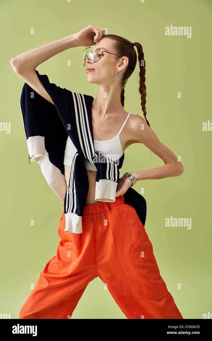 Woman poses against a soft green background, expressing individuality ...