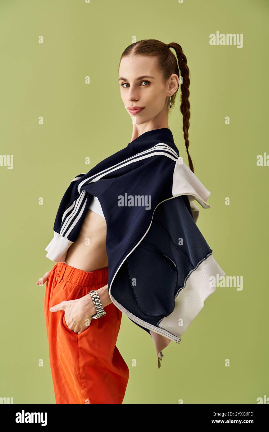 Young woman poses on a green backdrop, showcasing her strength and ...