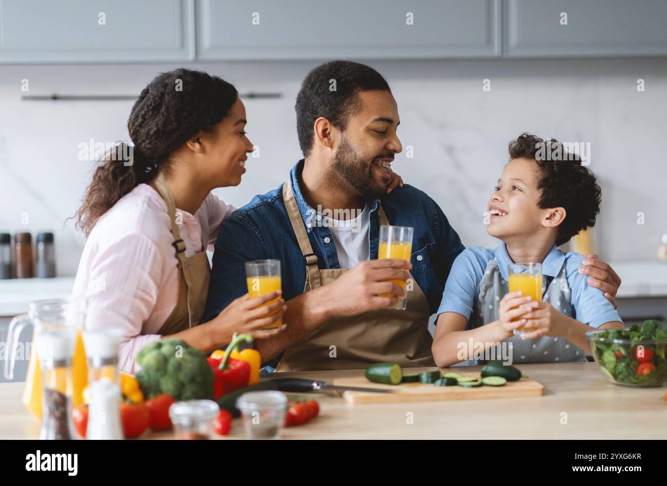 Family enjoys quality time together in the kitchen making healthy ...