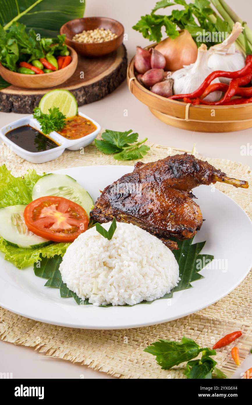 Bebek Bakar or Roasted duck with Sambal Terasi, a traditional food from Indonesia typical of ...