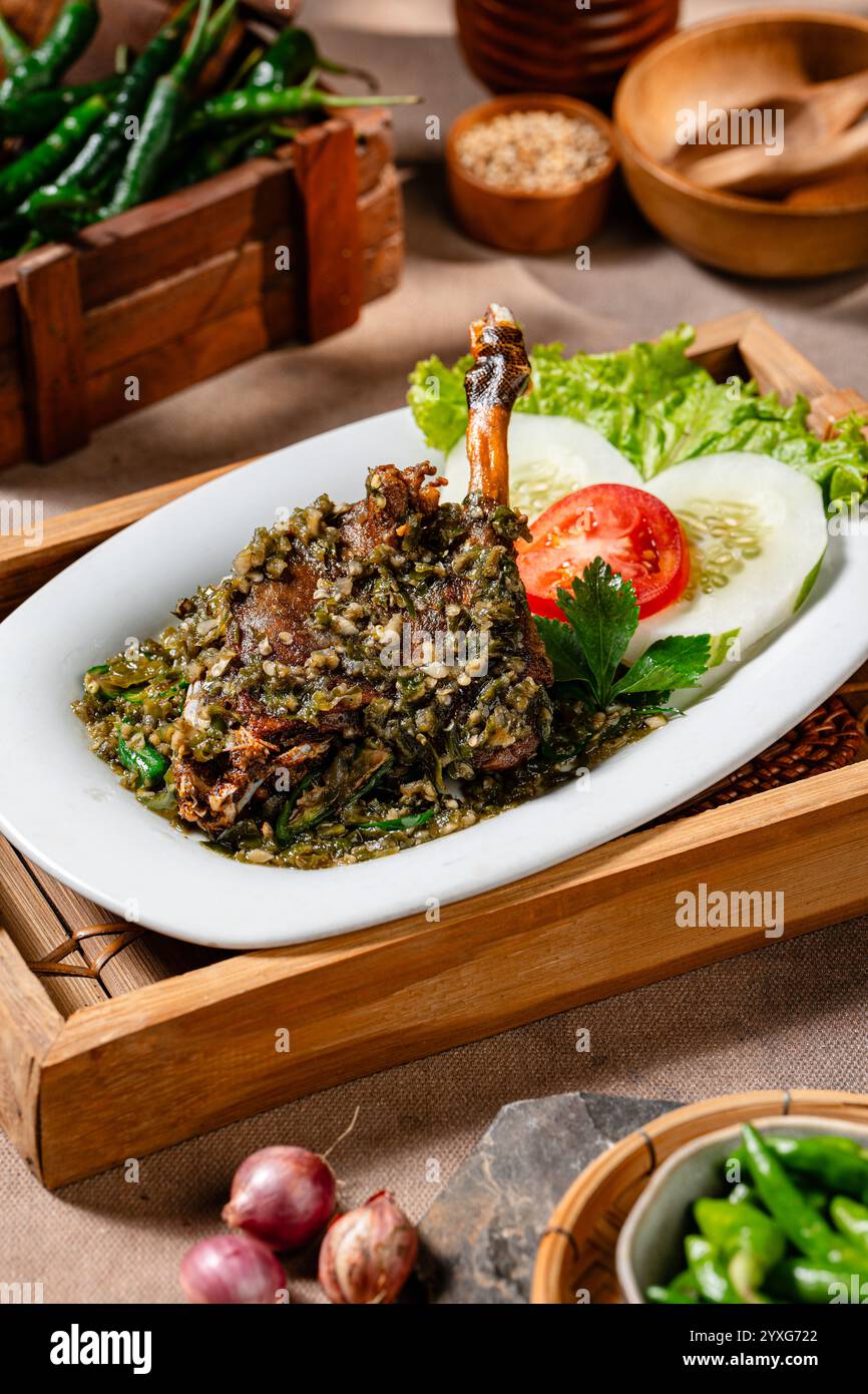 Bebek goreng cabe ijo or fried duck with green chili sauce. Traditional cuisine from West ...
