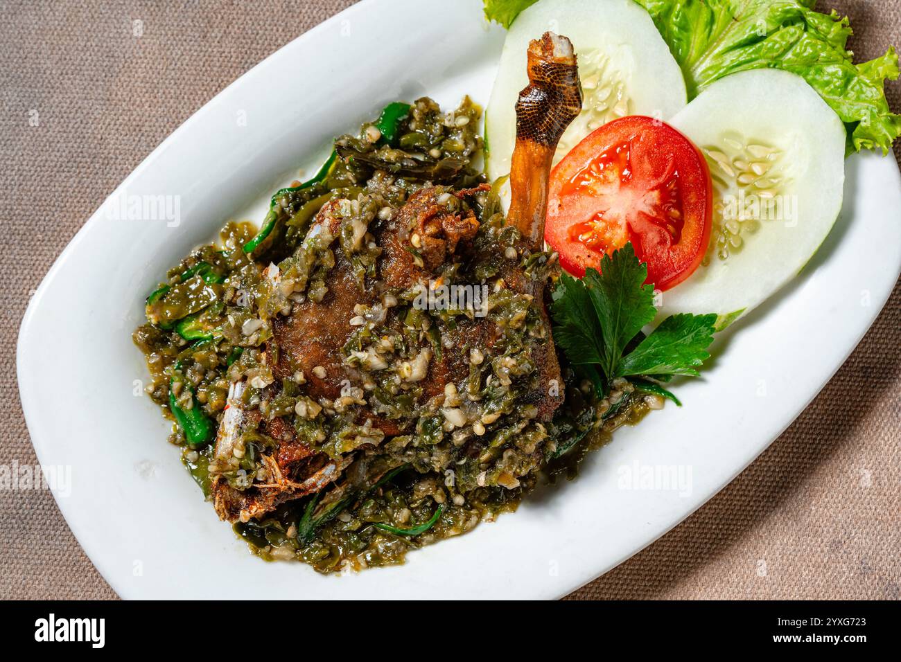 Bebek goreng cabe ijo or fried duck with green chili sauce. Traditional cuisine from West ...