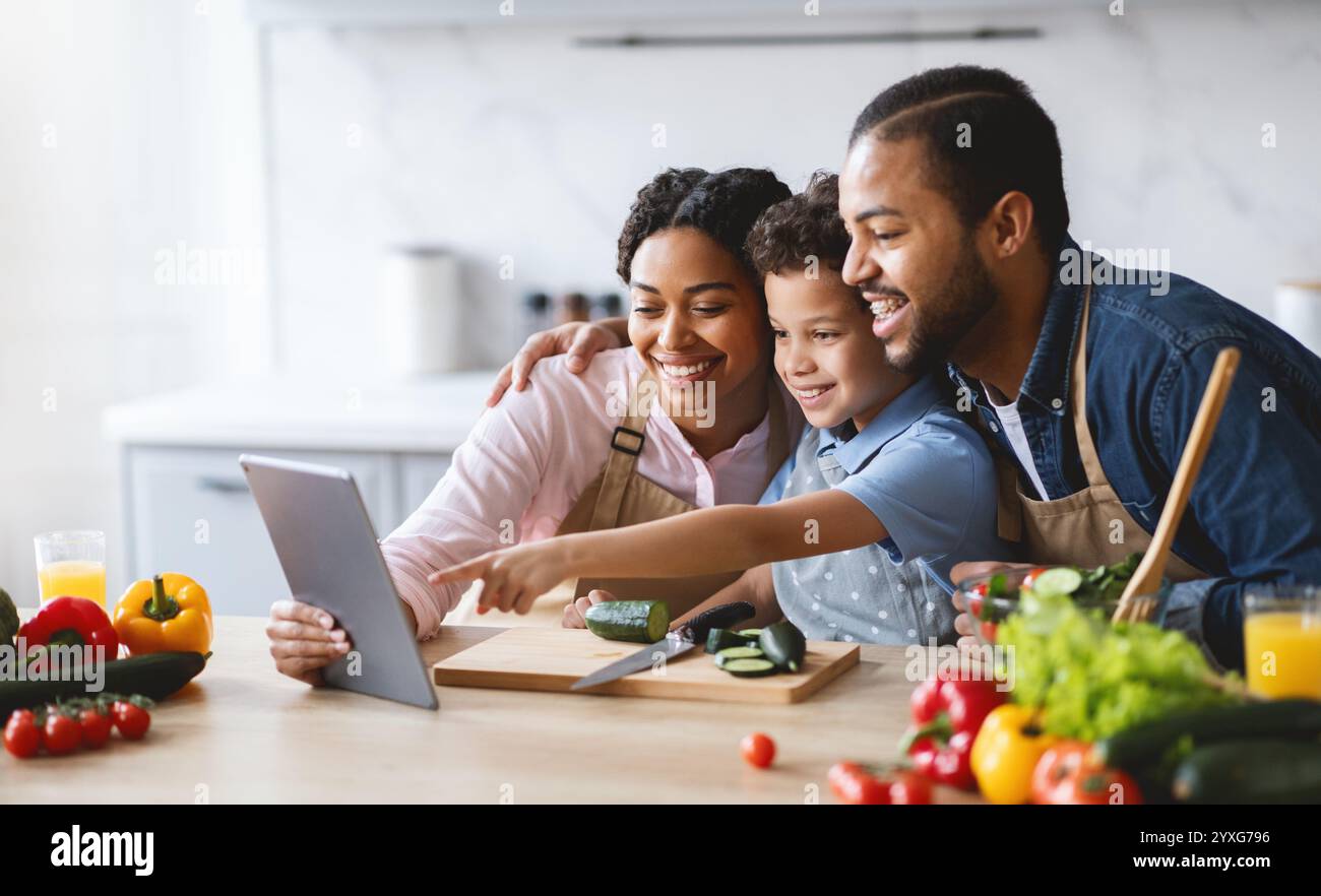 Family enjoys quality time together in the kitchen while cooking ...
