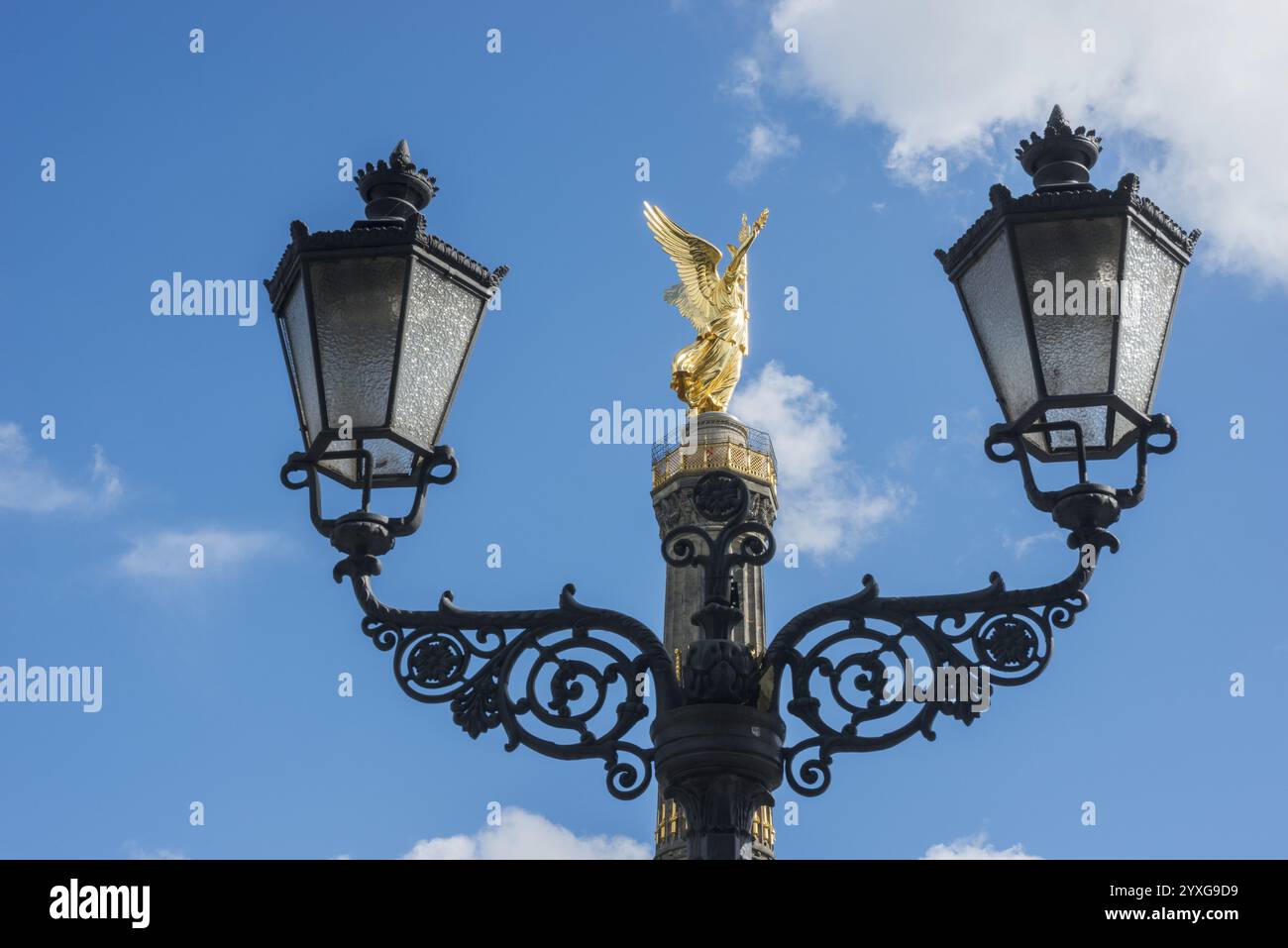 Victory Column behind a beautiful, old street lamp in a blue sky with ...