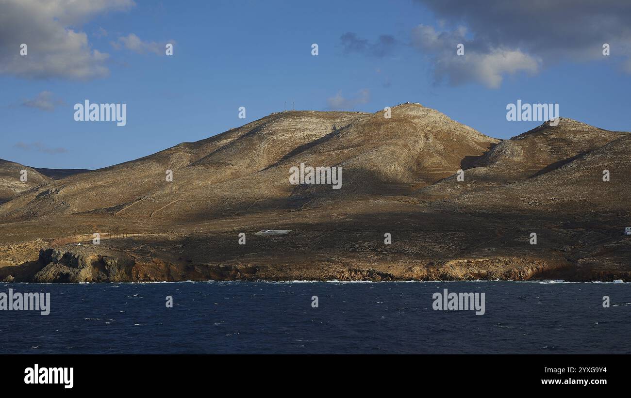 Hilly coastal area under a clear sky with shade on the slopes, Kassos ...