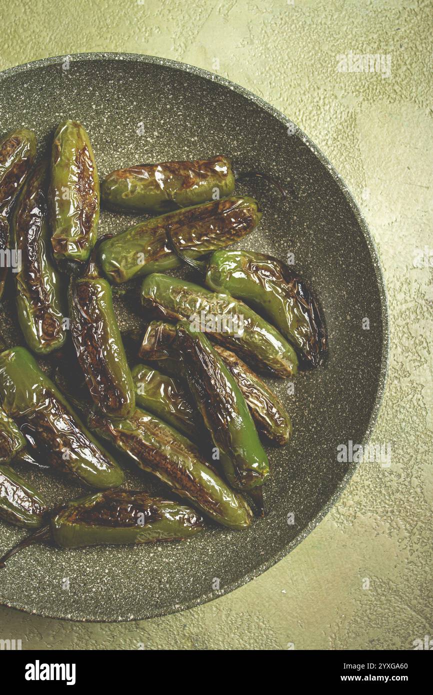 Fried padron pepper, in a frying pan, with olive oil, and sea salt ...