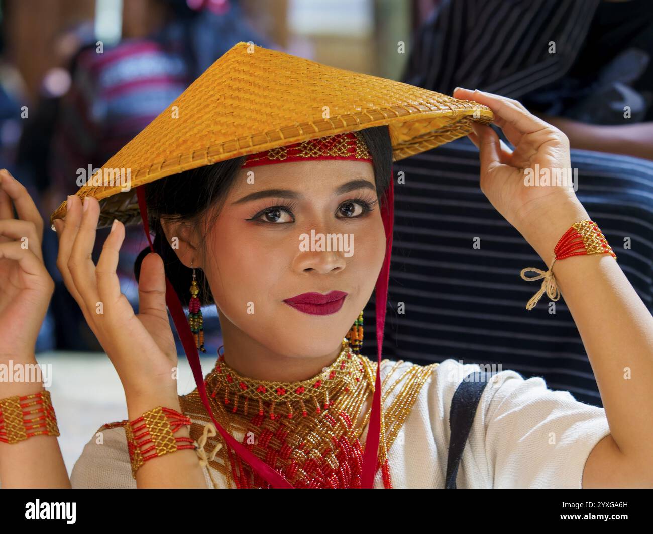 Toraja woman in traditional colourful clothing with rice straw hat, portrait, Tana Toraja ...