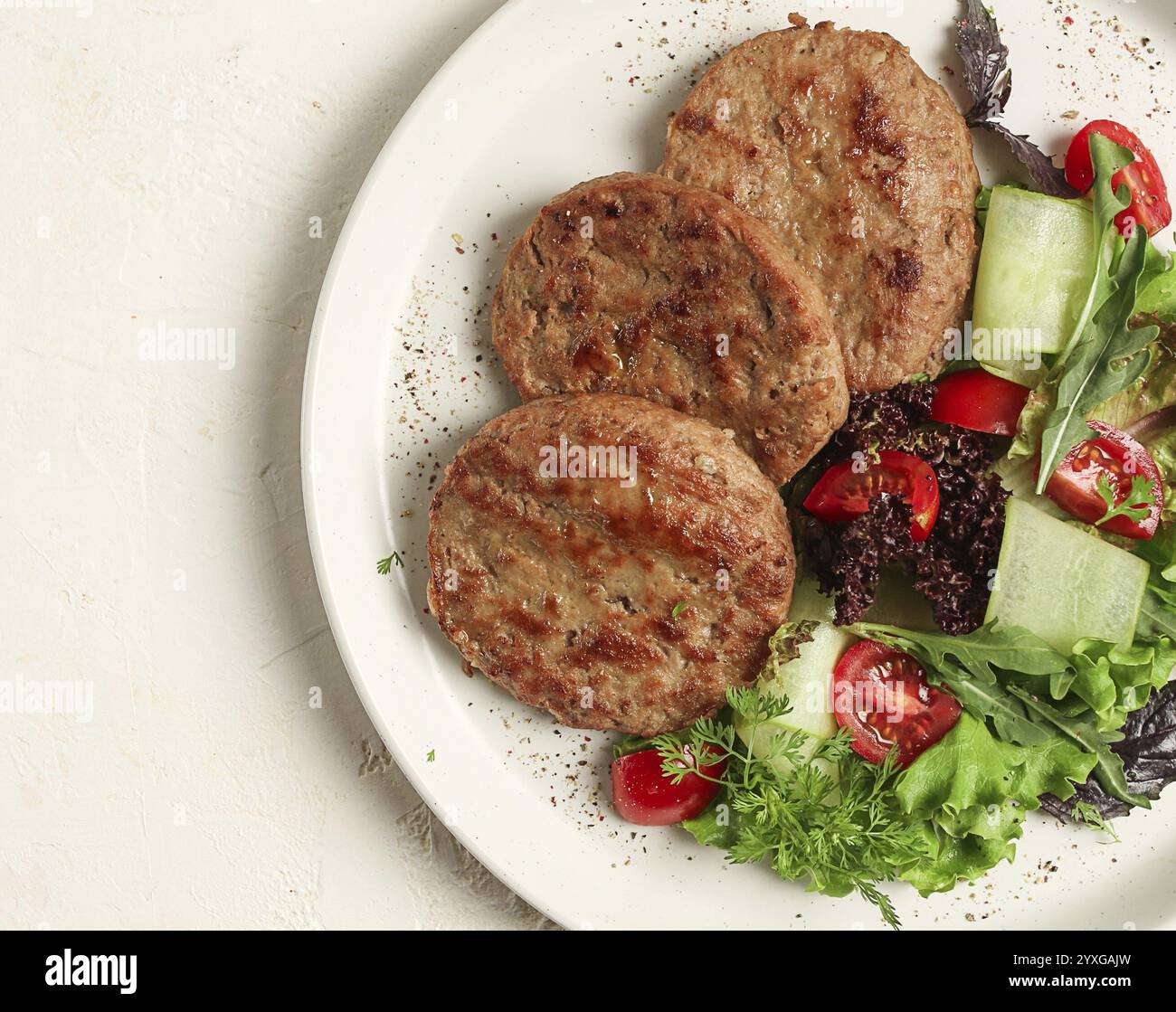 Fried cutlets, minced beef, with vegetable salad, top view, no people ...