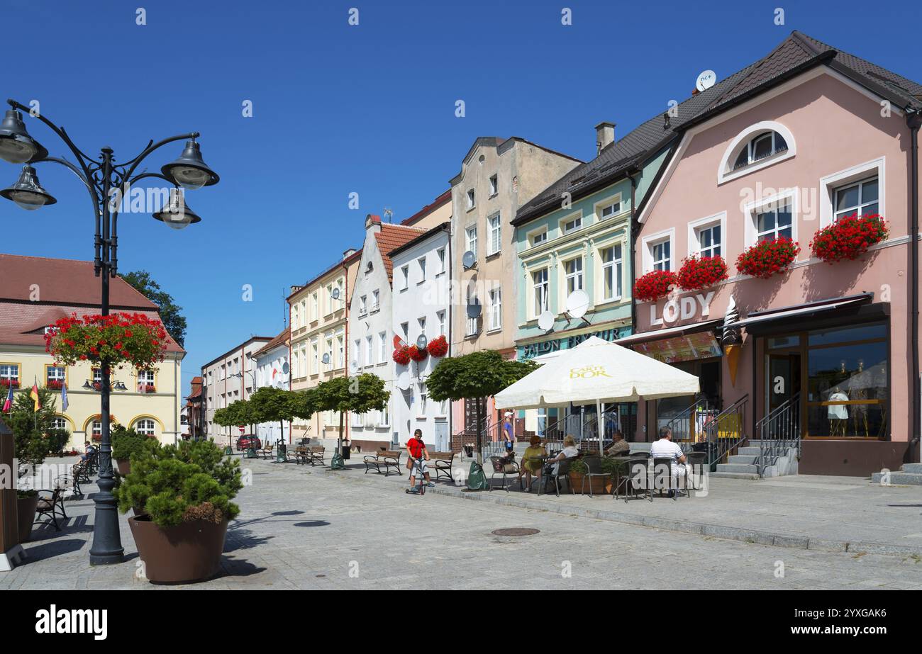 Colourful row of houses in a sunny street with cafes and people ...