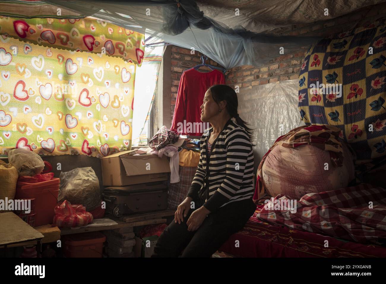 Labourer Ma Jian Hui at her sleeping place, the workers live in the ...
