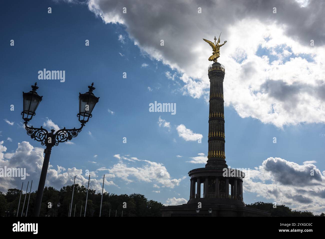 Victory Column next to an old street lamp in a dramatically cloudy sky ...