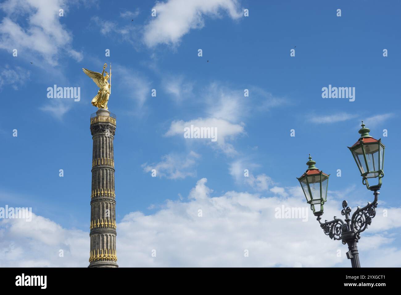 Victory Column next to a beautiful, old street lamp in a blue sky with ...