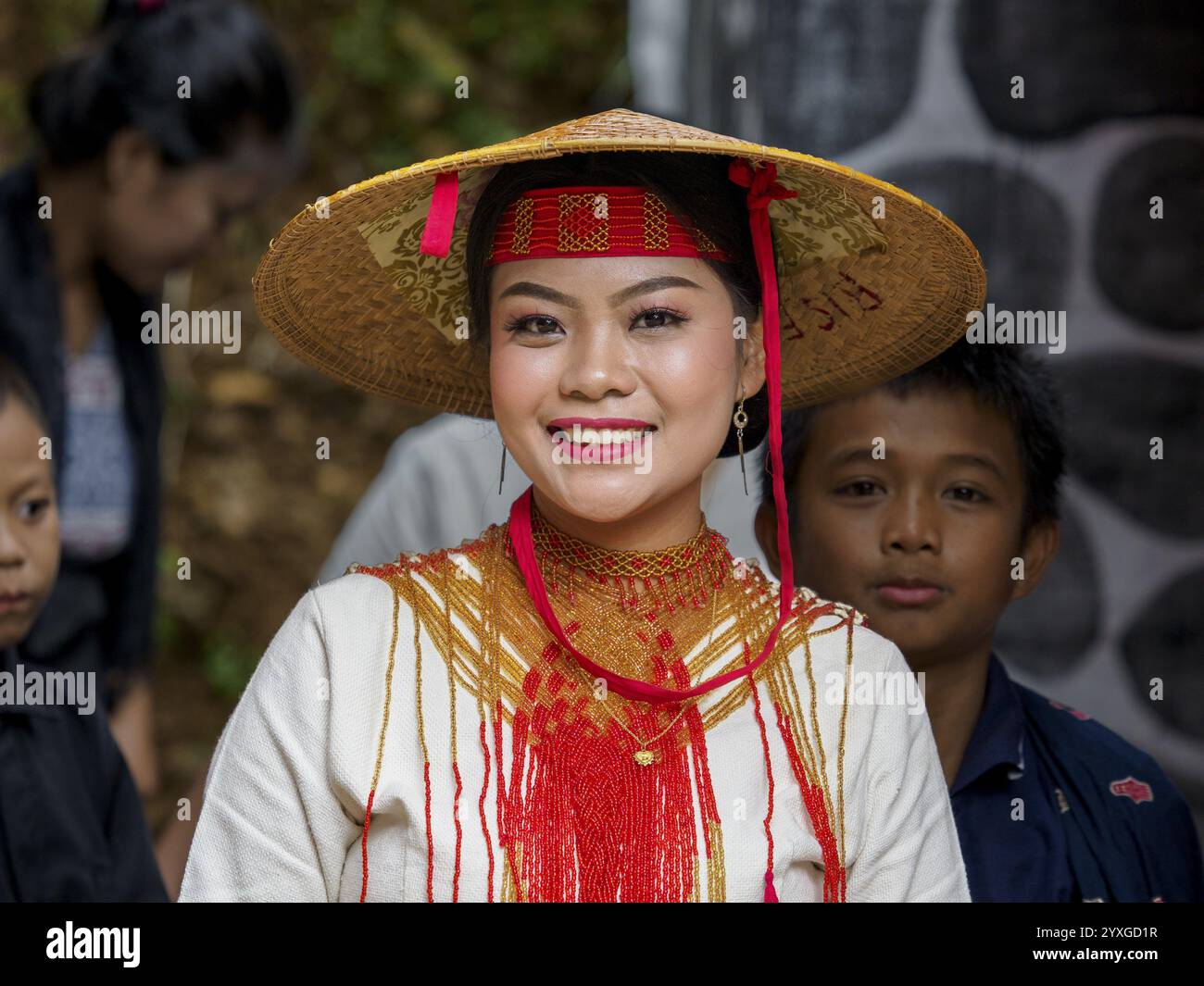Toraja woman in traditional colourful clothes with rice straw hat ...