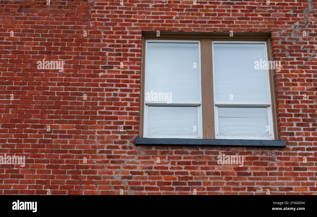 Rustic red brick wall with wooden glass window. Exterior view of the ...
