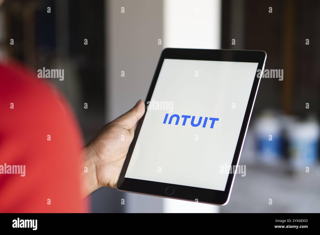 Intuit logo is displayed on smartphone. Intuit Inc. is an American ...