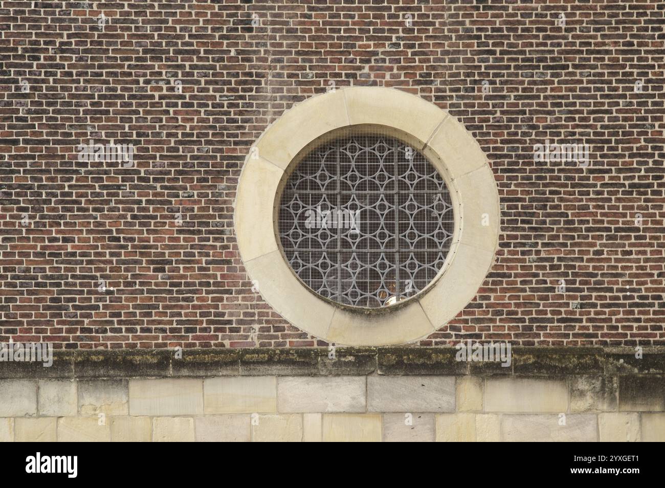 Sunlight streaming through a circular window with a geometric metal ...