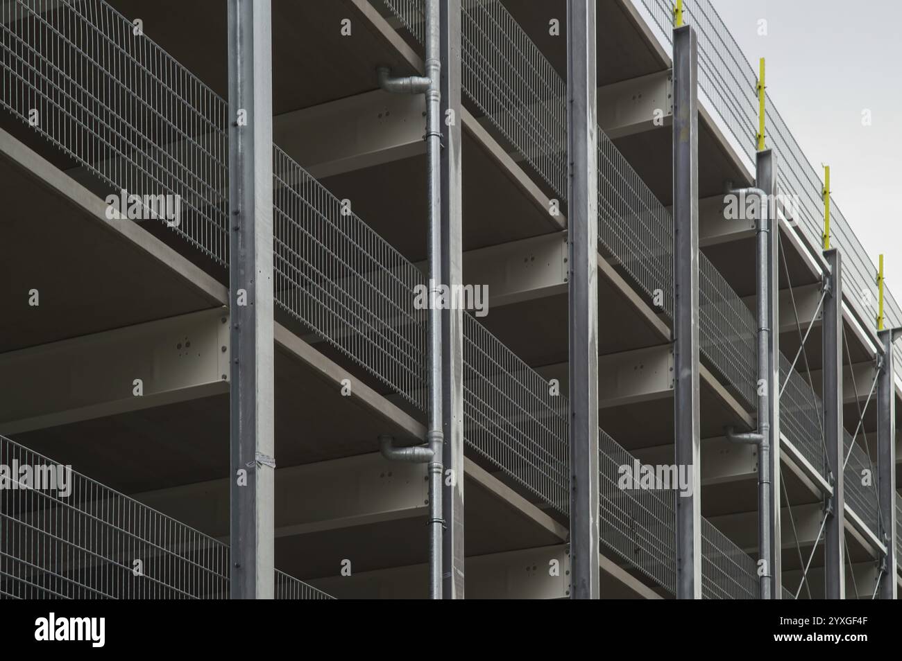 Modern parking garage levels with metal grid railing and support ...