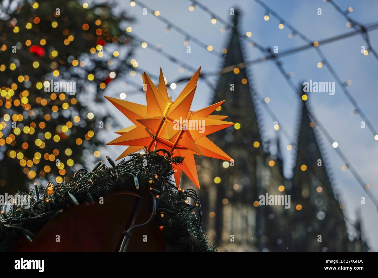 Christmas market at Cologne Cathedral, shining yellow star on a ...