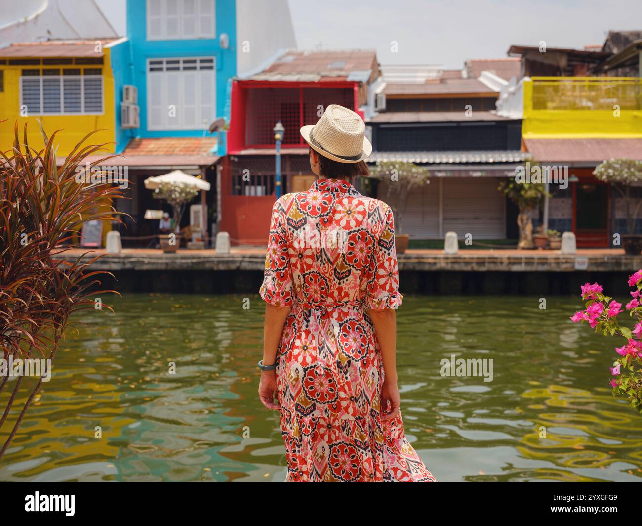 Young woman in ethnic dress and hat exploring the vibrant streets of ...