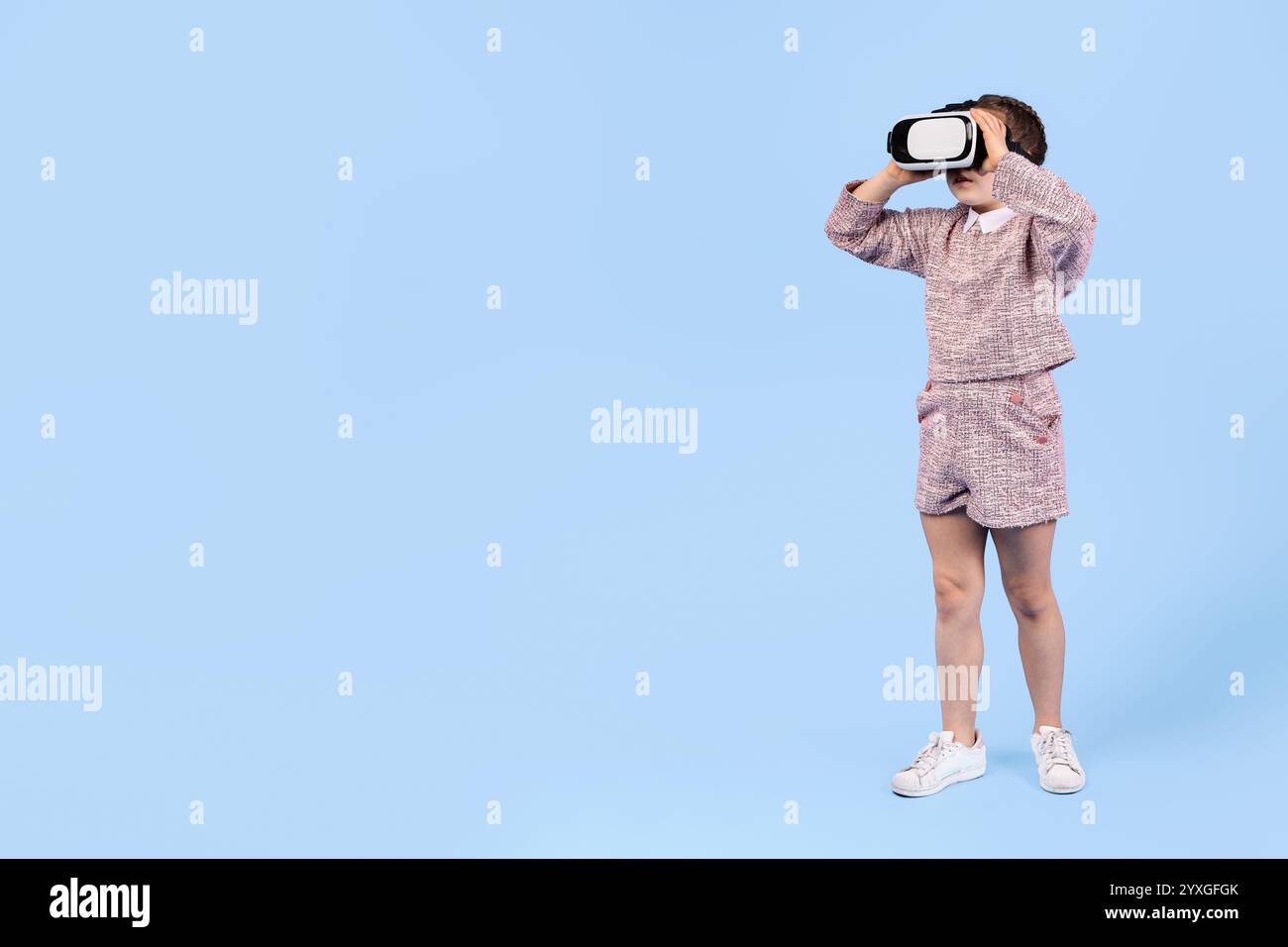 Happy girl exploring virtual reality in a fun and colorful setting ...