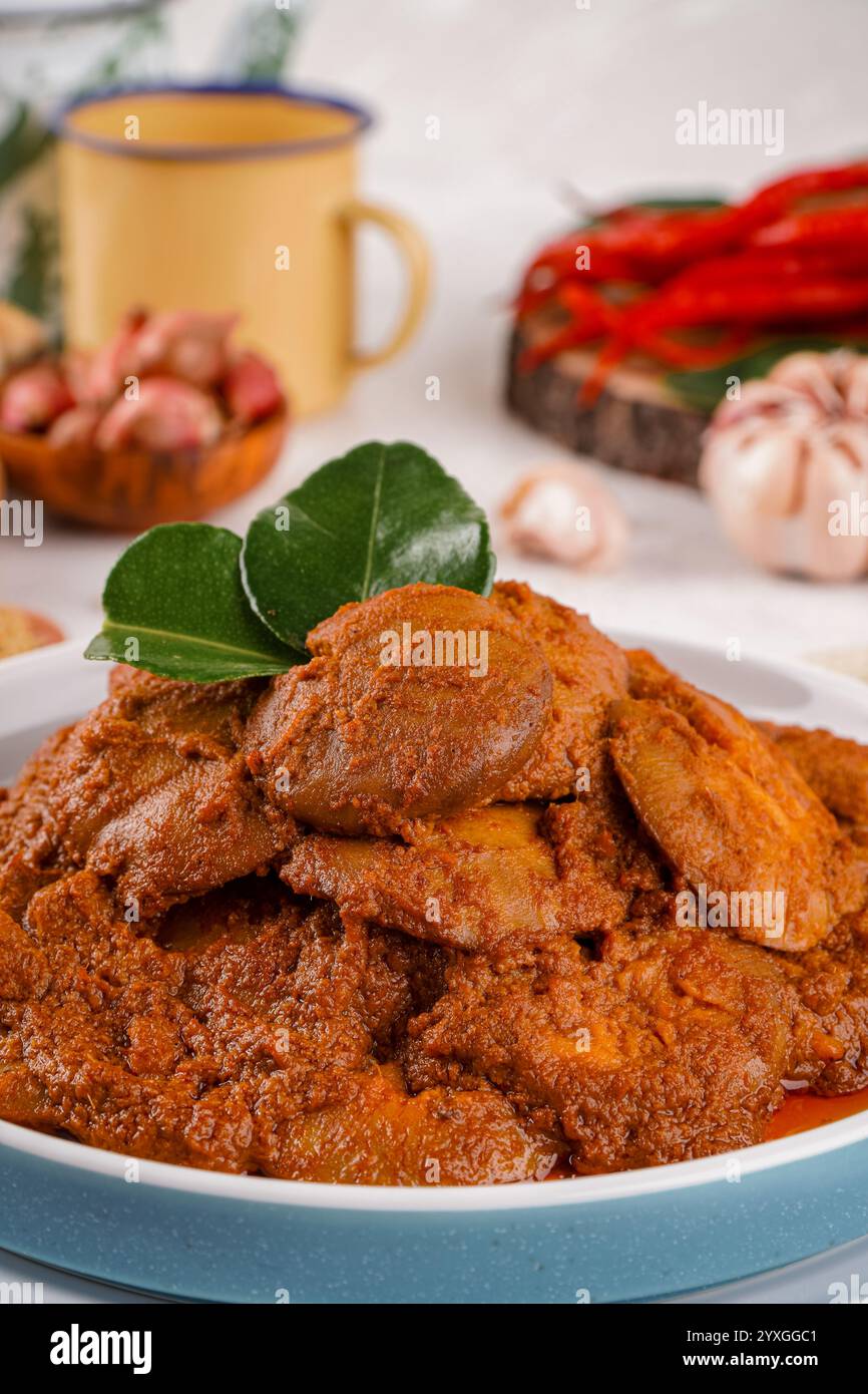 Rendang Jengkol, dogfruit simmered in spices and coconut milk. Indonesian traditional comfort ...