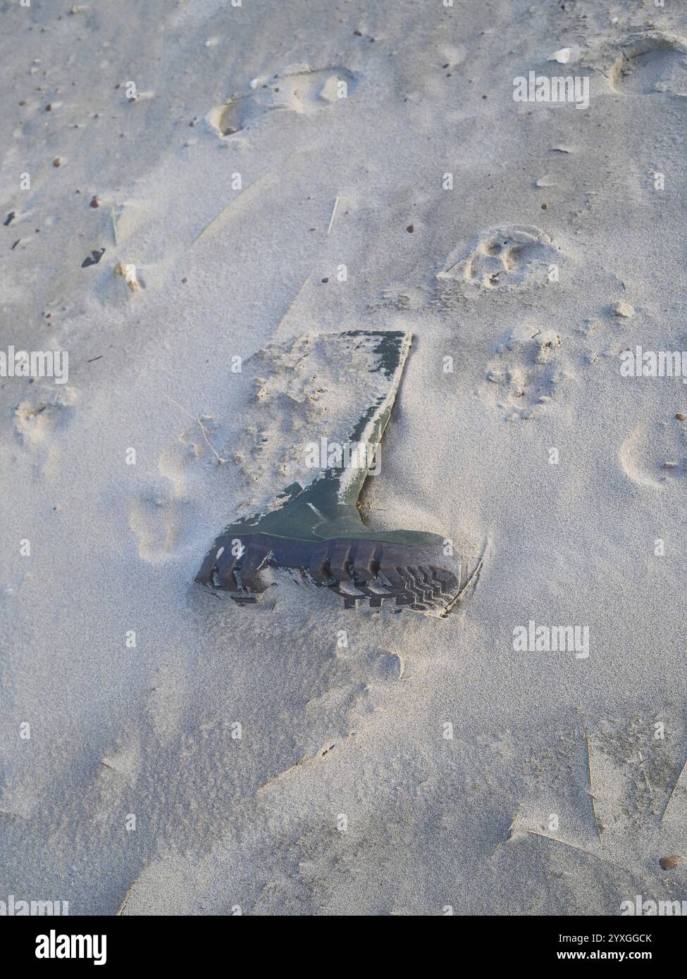 A lost wellington boot on the North Sea beach, Brouwersdam, province of ...