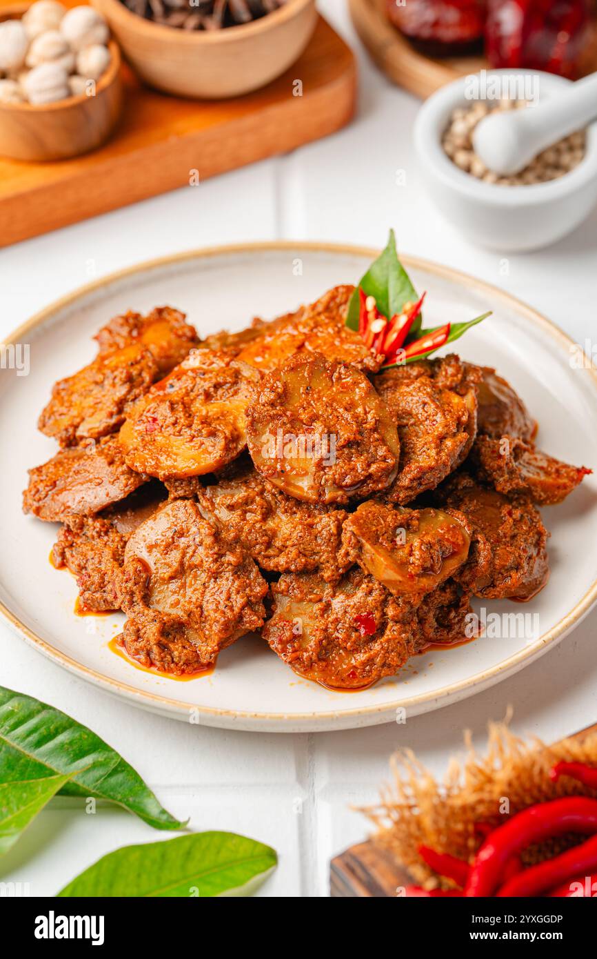 Rendang Jengkol, dogfruit simmered in spices and coconut milk. Indonesian traditional comfort ...