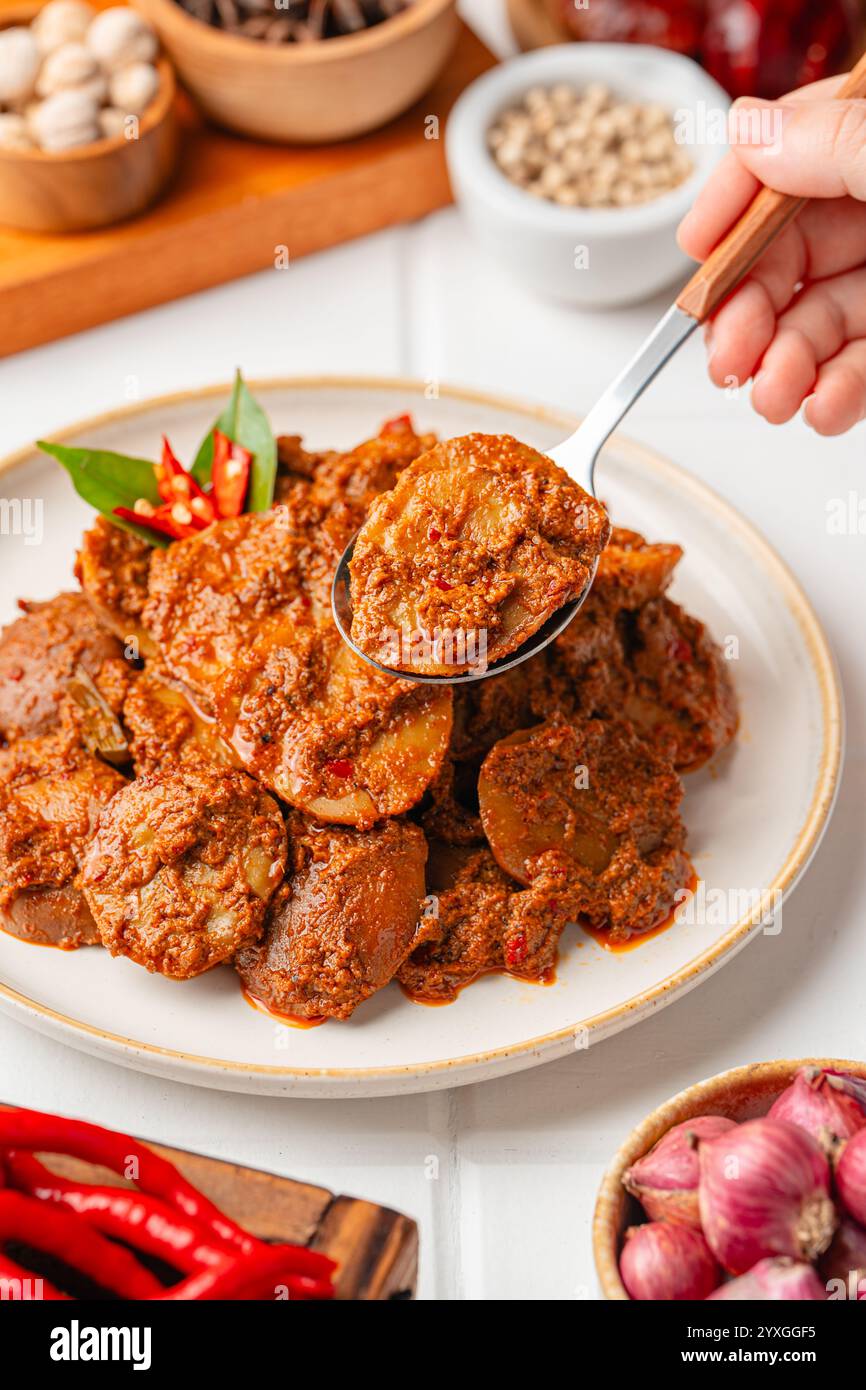 Rendang Jengkol, dogfruit simmered in spices and coconut milk. Indonesian traditional comfort ...