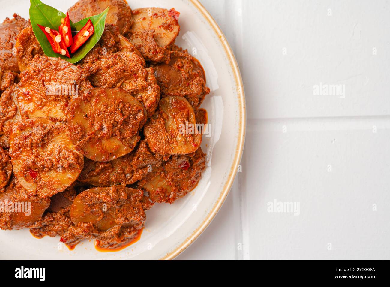 Rendang Jengkol, dogfruit simmered in spices and coconut milk. Indonesian traditional comfort ...