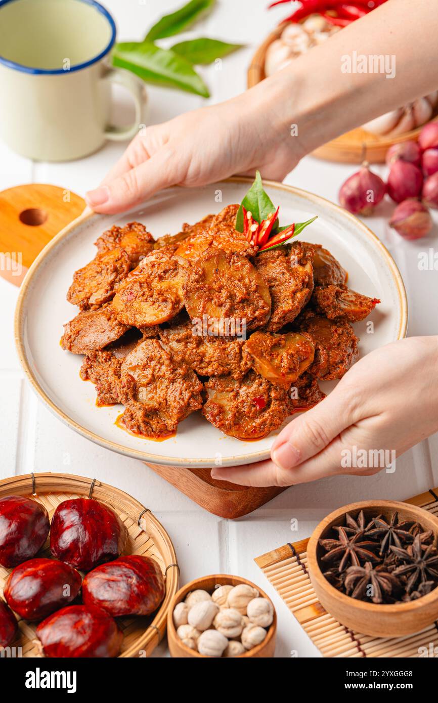 Rendang Jengkol, dogfruit simmered in spices and coconut milk. Indonesian traditional comfort ...