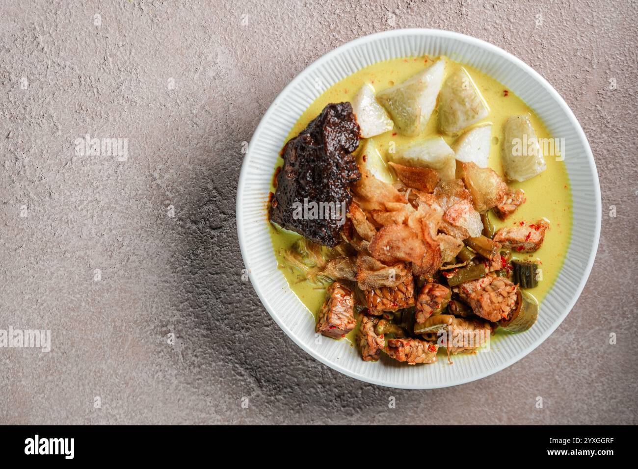 Lontong sayur or vegetable rice cake is an Indonesian traditional rice ...
