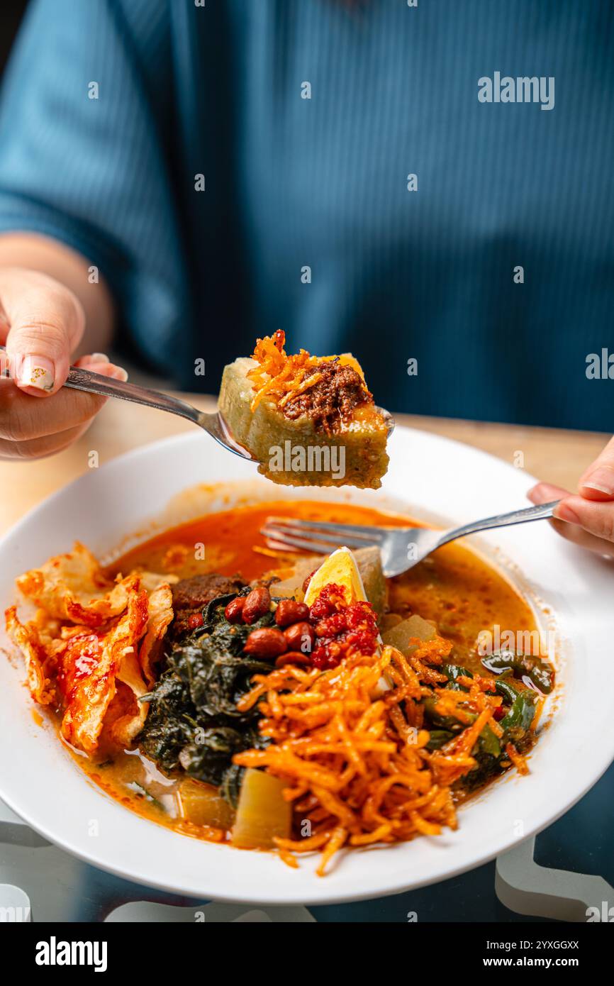 Lontong sayur or vegetable rice cake is an Indonesian traditional rice ...