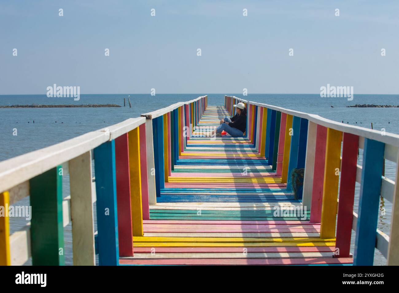 Colorful rainbow wooden bridge, a coastal community near Wat Kaew ...