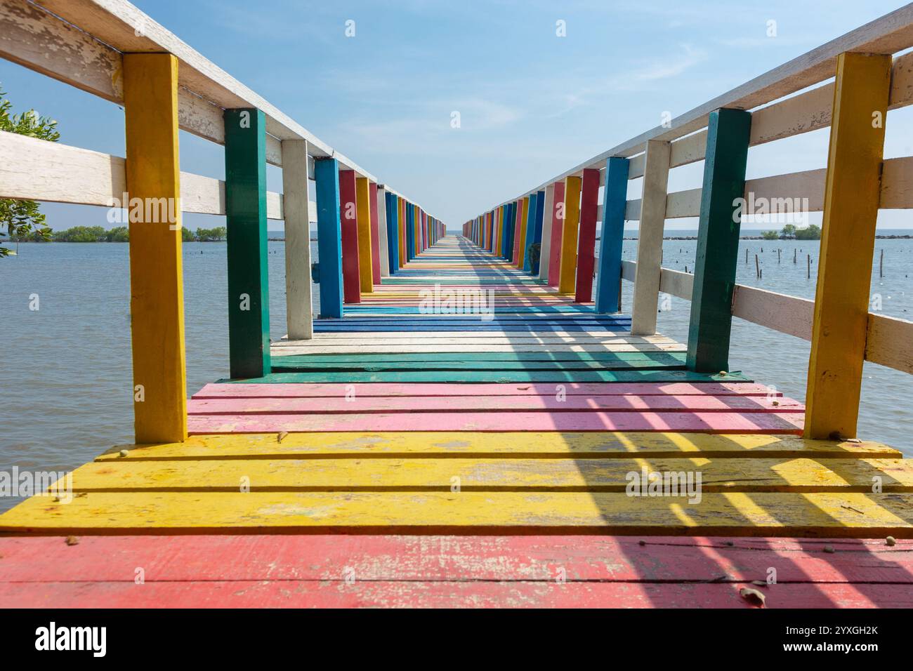 Colorful rainbow wooden bridge, a coastal community near Wat Kaew ...