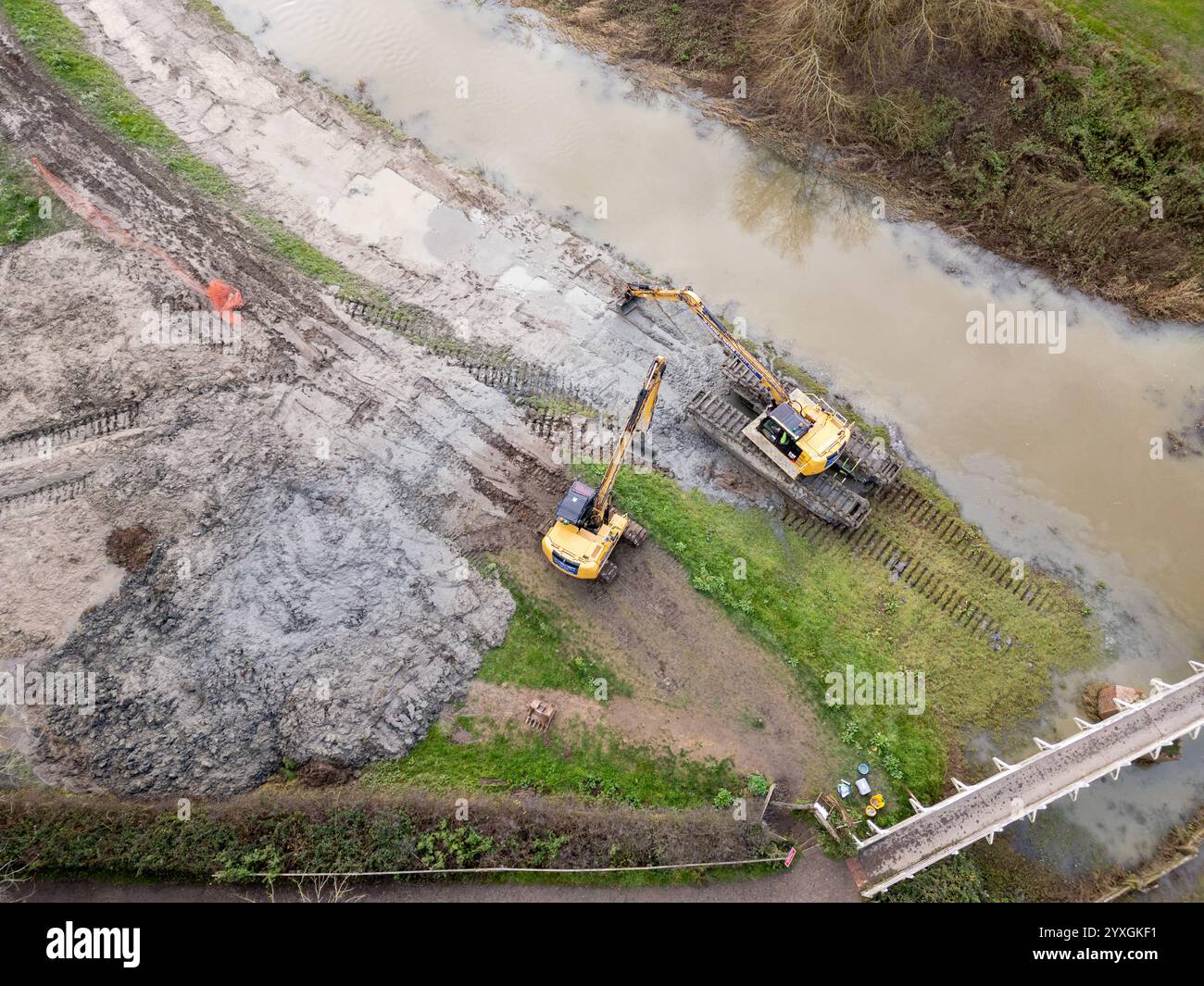 An amphibious excavator (one of three in the country) and a standard excavator excavating the ...