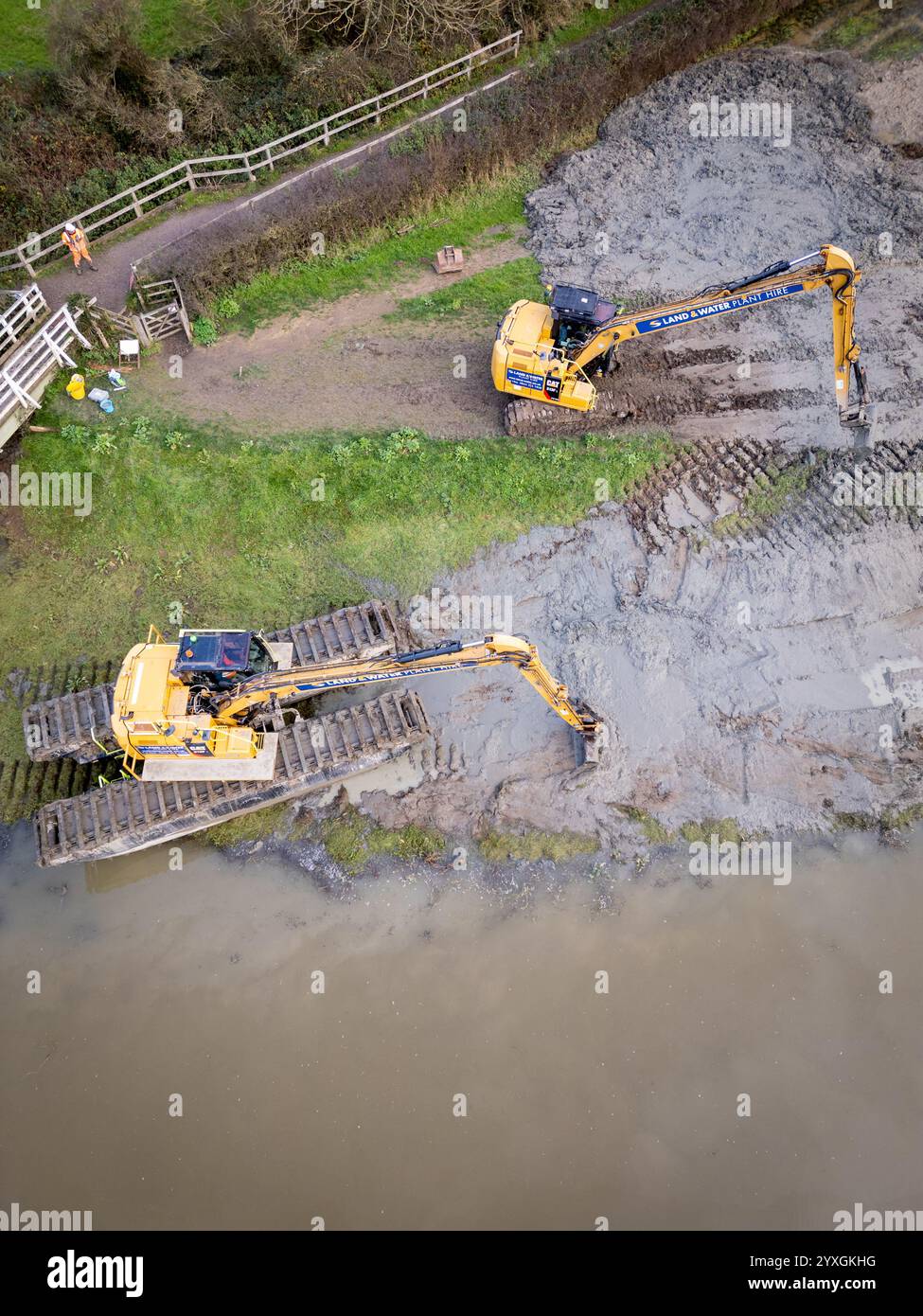 An amphibious excavator (one of three in the country) and a standard excavator excavating the ...