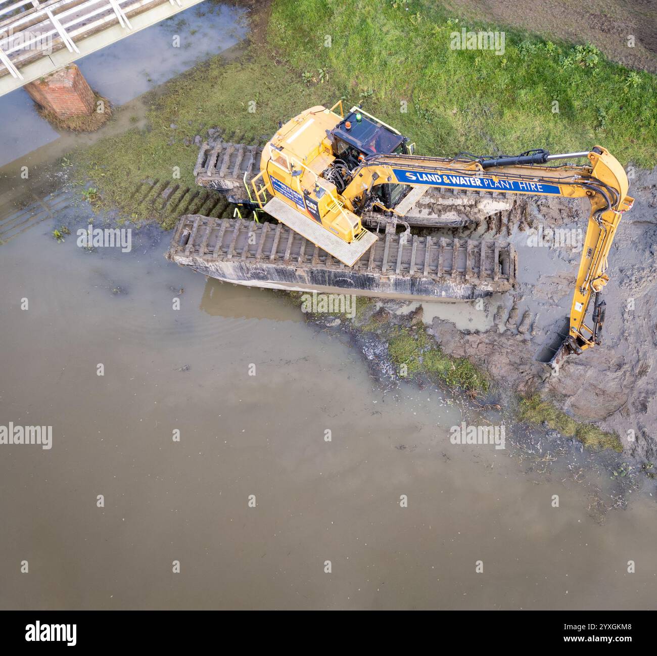 An amphibious excavator (one of three in the country) excavating the riverbed at Alfriston. The ...