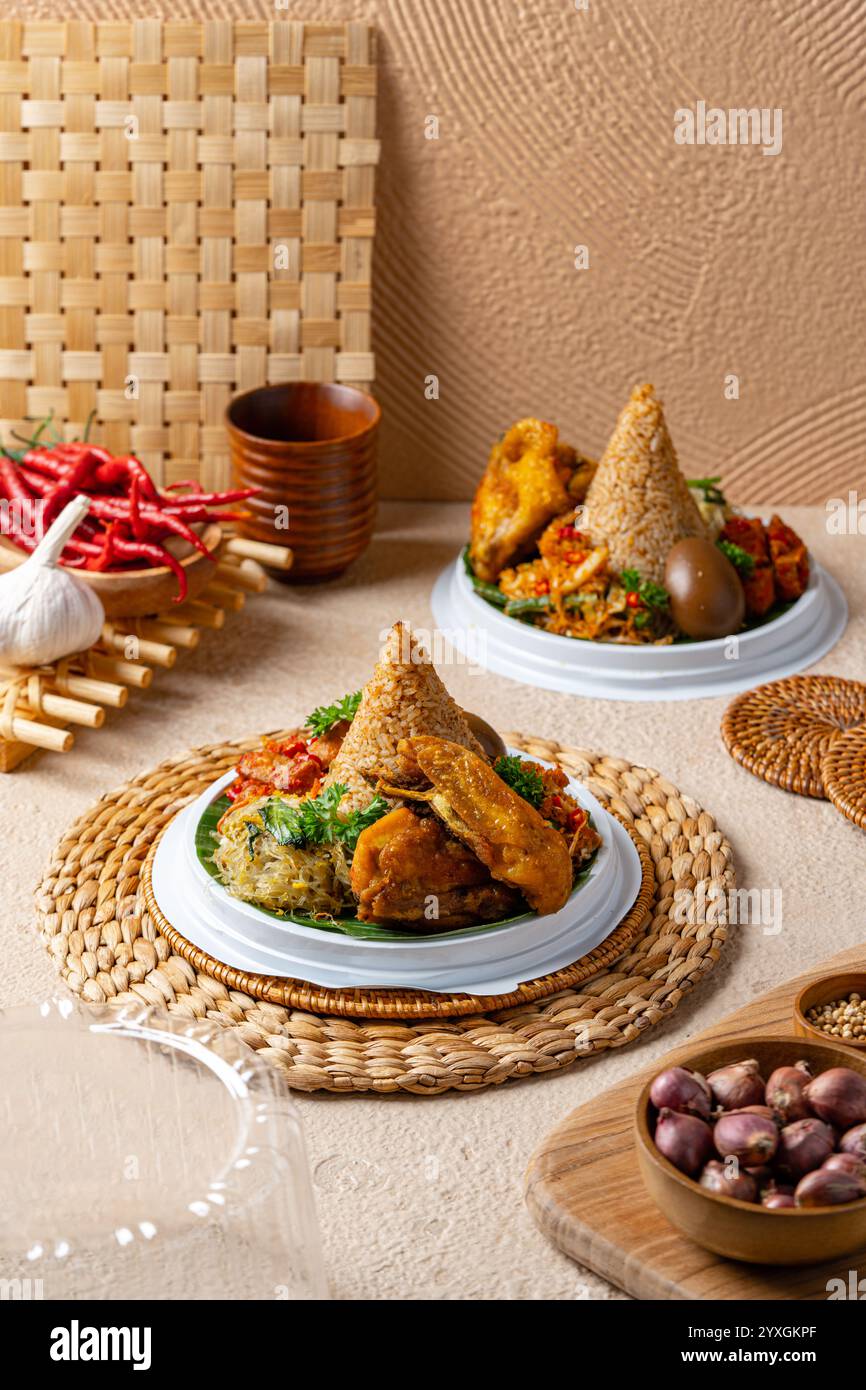 Tumpeng is an Indonesian cone-shaped rice dish with side dishes of ...