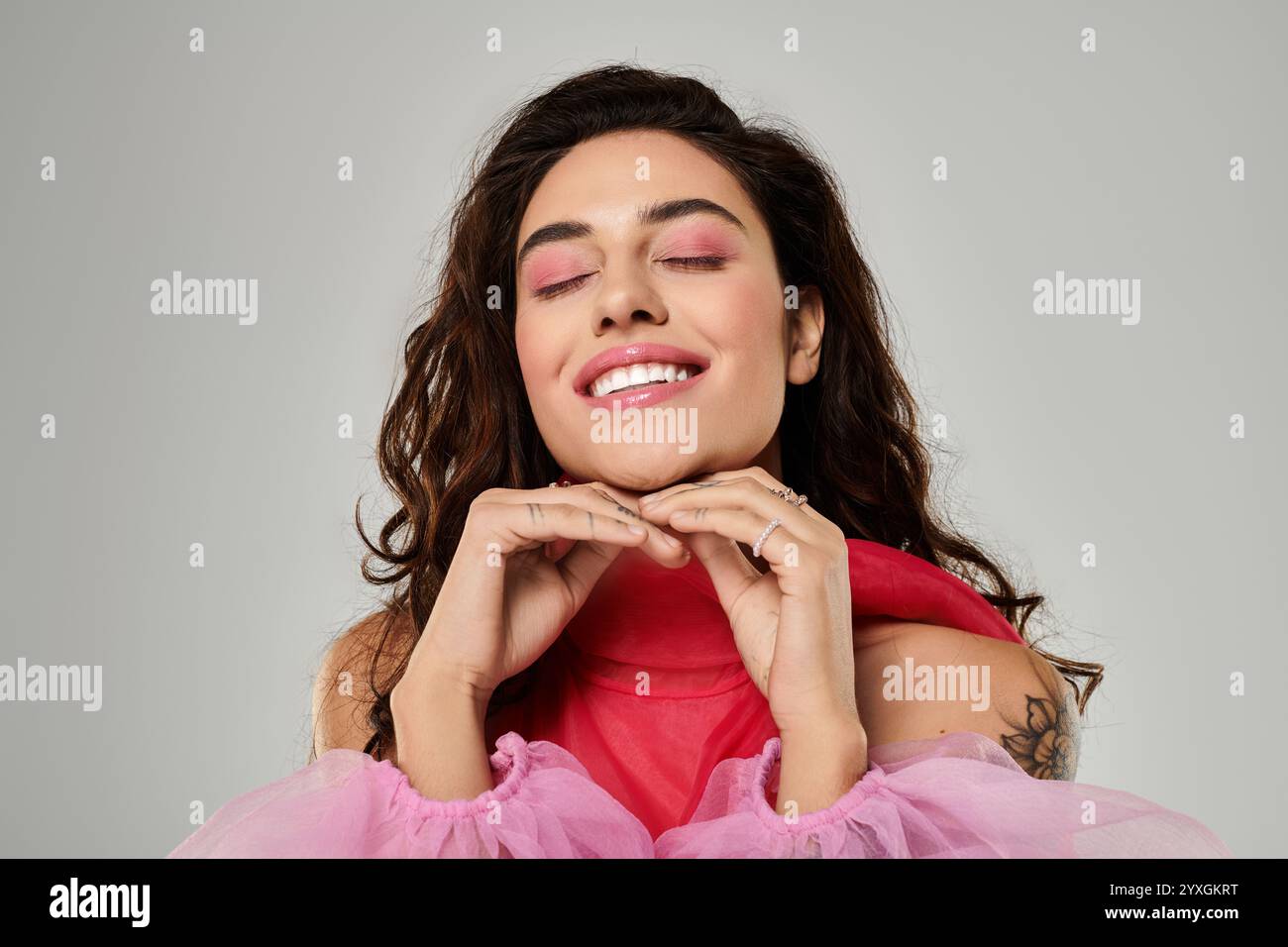 Beautiful young woman showcases her playful spirit with a radiant smile ...