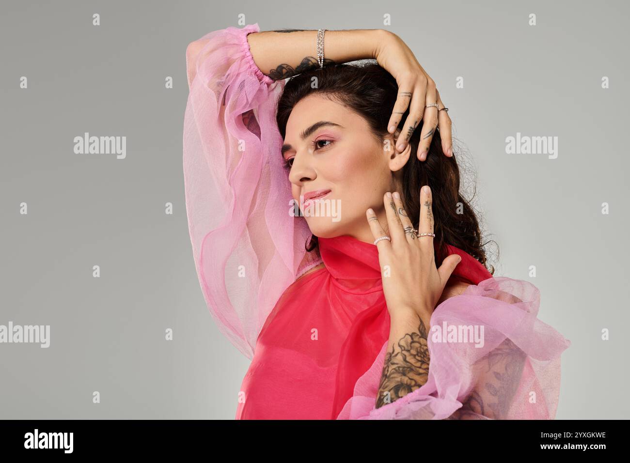 A young beautiful woman showcases her style through graceful poses and ...