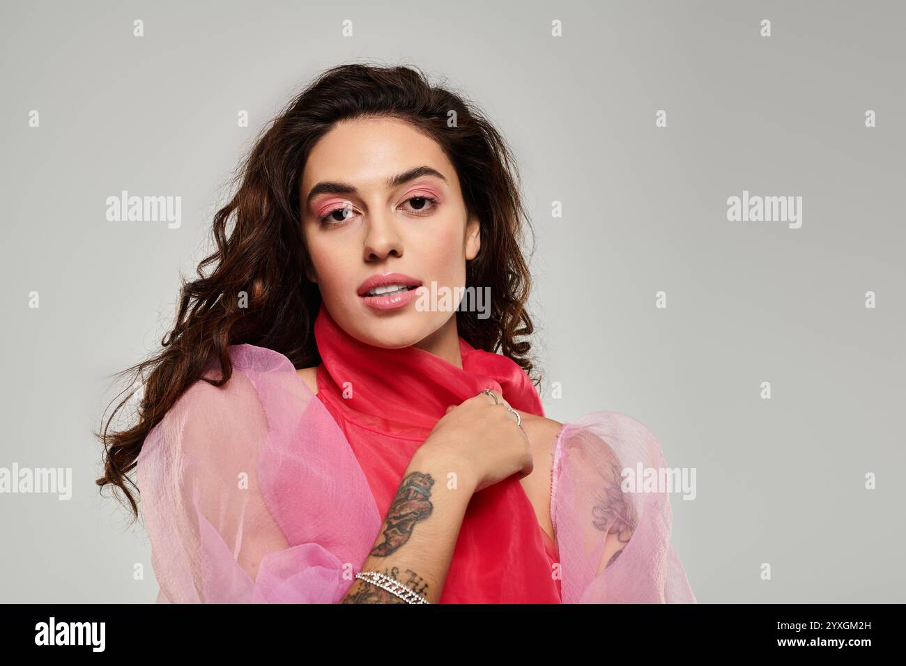 Beautiful young woman with stylish attire and captivating makeup poses ...