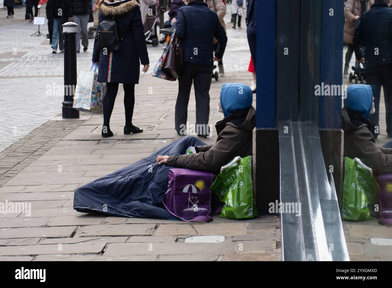 Windsor, Berkshire, UK. 16th December, 2024. A homeless man sits on the ...