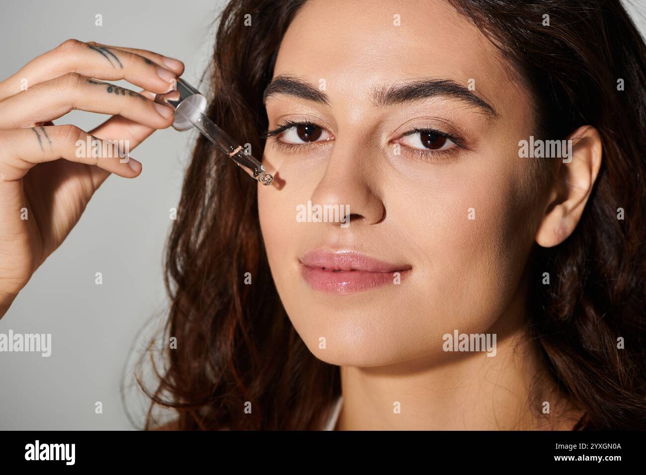 Woman uses dropper apply serum hi-res stock photography and images - Alamy